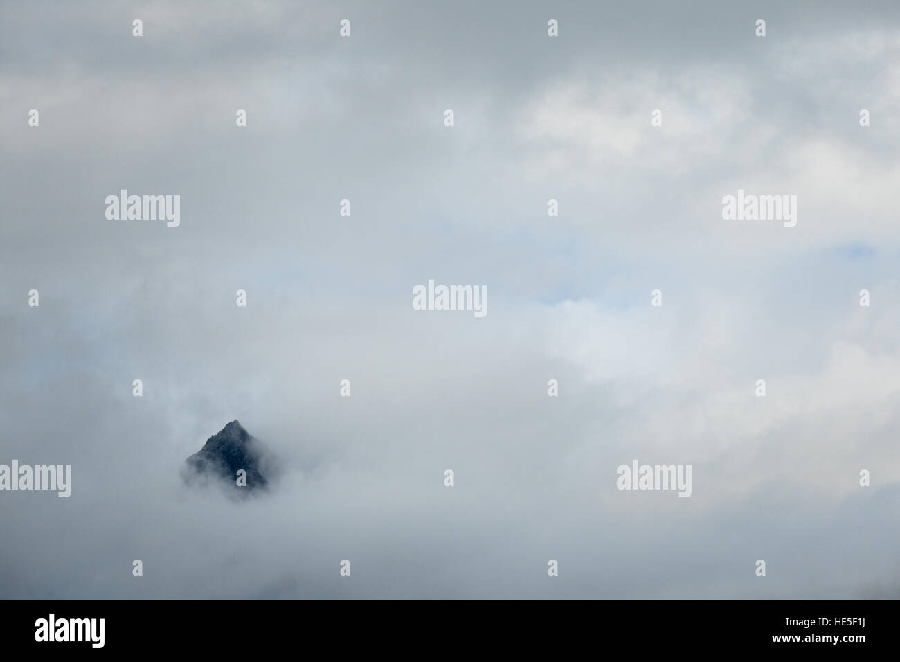Only a peak of the mountain visible from the clouds at Himachal Pradesh ...