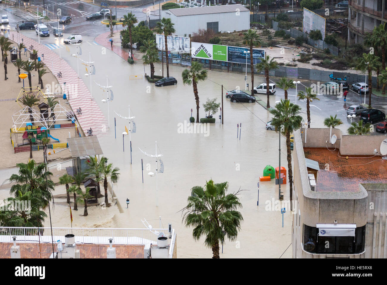 Vehicles drive through flooded streets in La Cala, Alicante province ...
