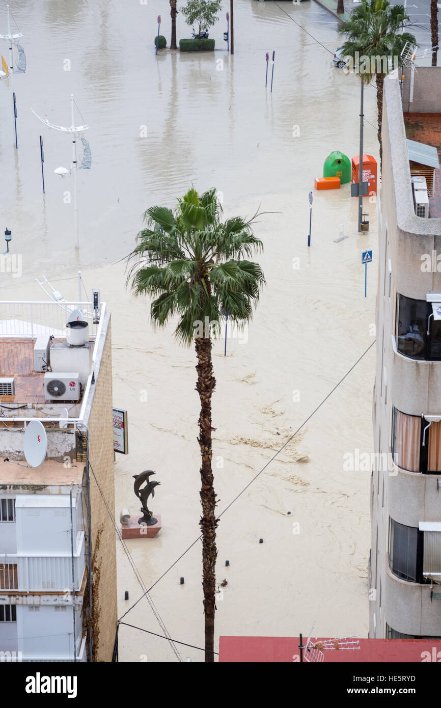 Vehicles drive through flooded streets in La Cala, Alicante province ...