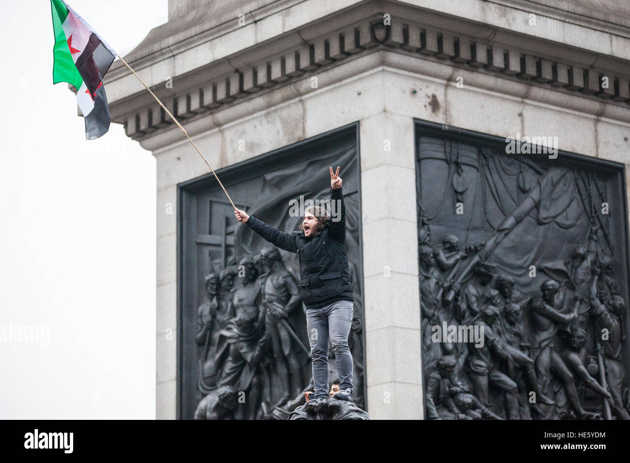 London, UK. 17th December, 2016. A man with a Syrian flag observes the ...