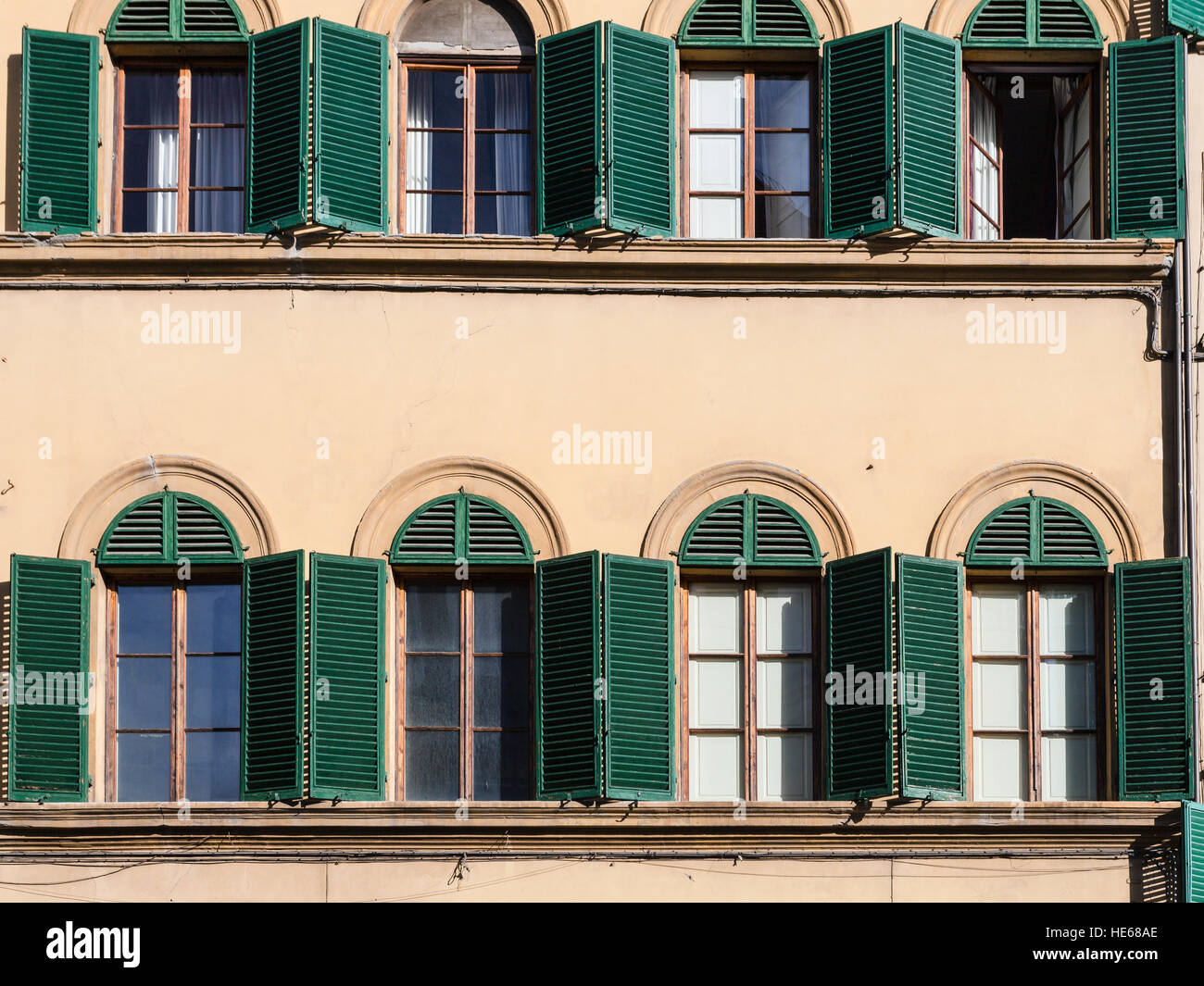 travel to Italy - facade of urban house with green window blinds in ...