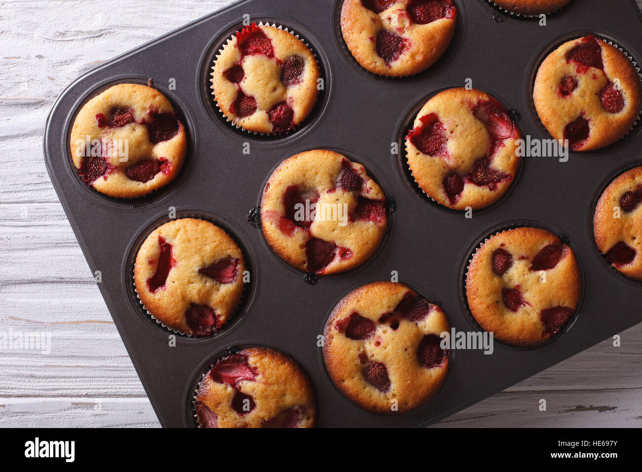 berry strawberry muffins in baking dish. horizontal view from above ...