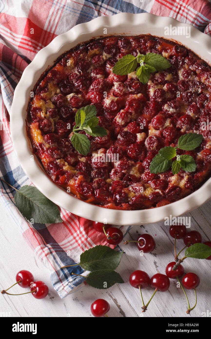 homemade cherry pie Clafoutis closeup in a dish for baking. vertical ...