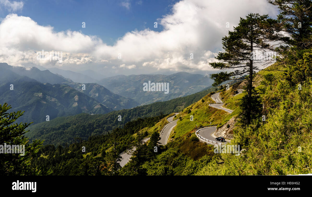 The road clings to the mountains, winding its way up and down, one bend ...