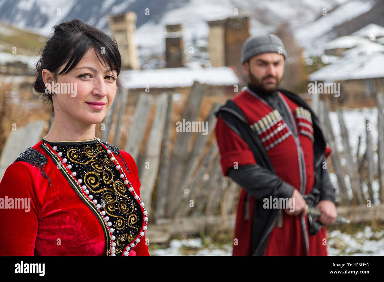 Georgian couple in national clothes in Ushguli, Georgia with medieval ...