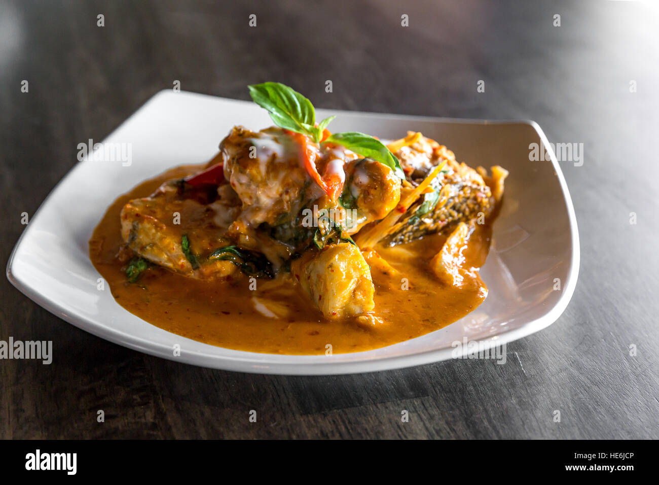 Fried grouper Fish with Red Curry Paste Chu Chee Pla Stock Photo - Alamy