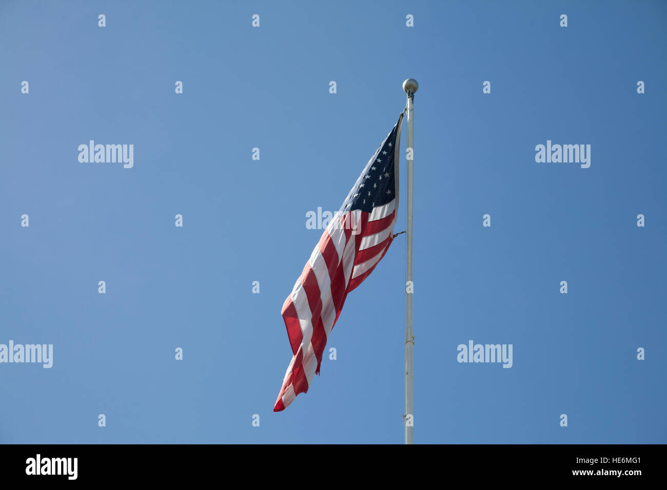 American flag flapping against a beautiful blue background Stock Photo ...