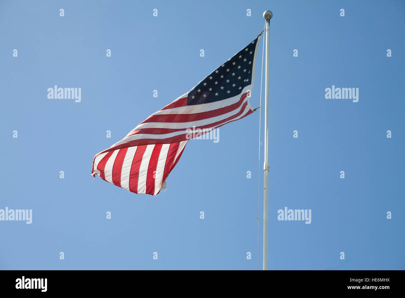 American flag flapping against a beautiful blue background Stock Photo ...