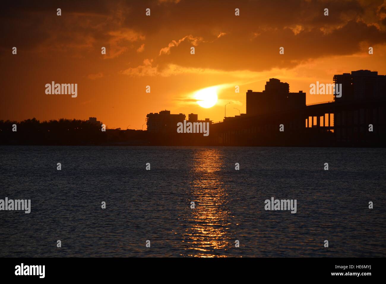 Miami sunset with Rickenbacker bridge and buildings in the back ...