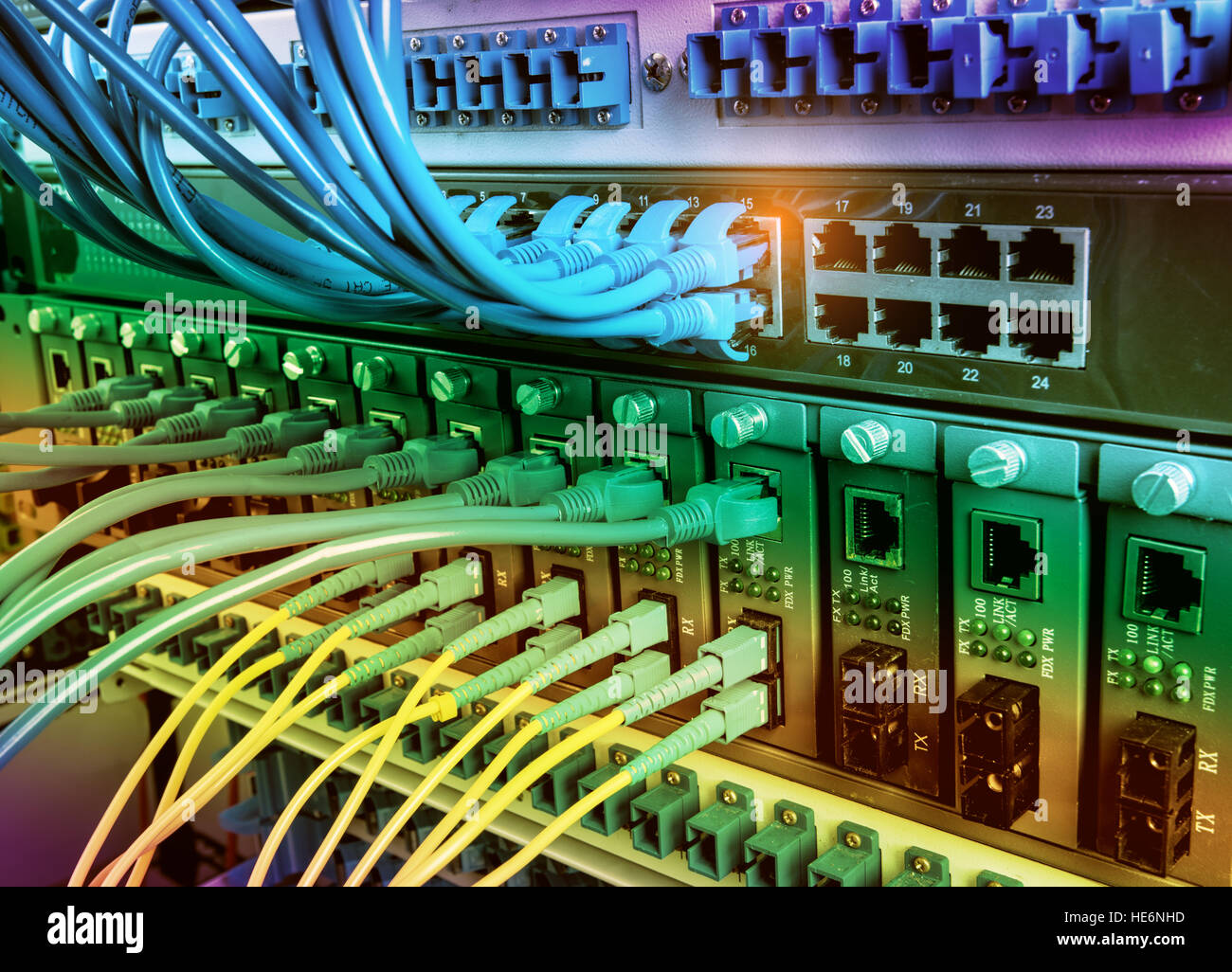 Fiber Optic cables connected to an optic ports and Network cables ...