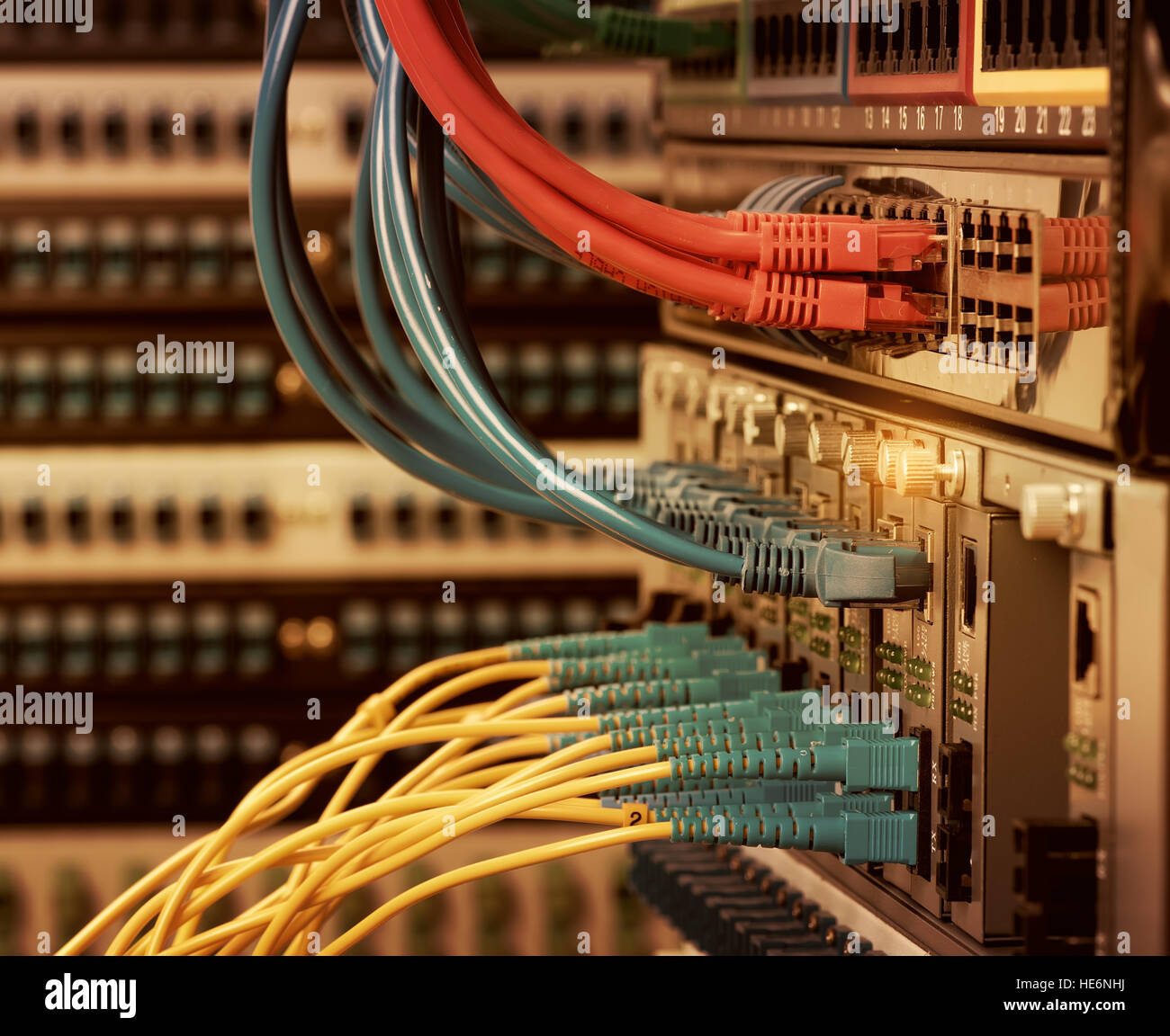 Fiber Optic cables connected to an optic ports and Network cables ...