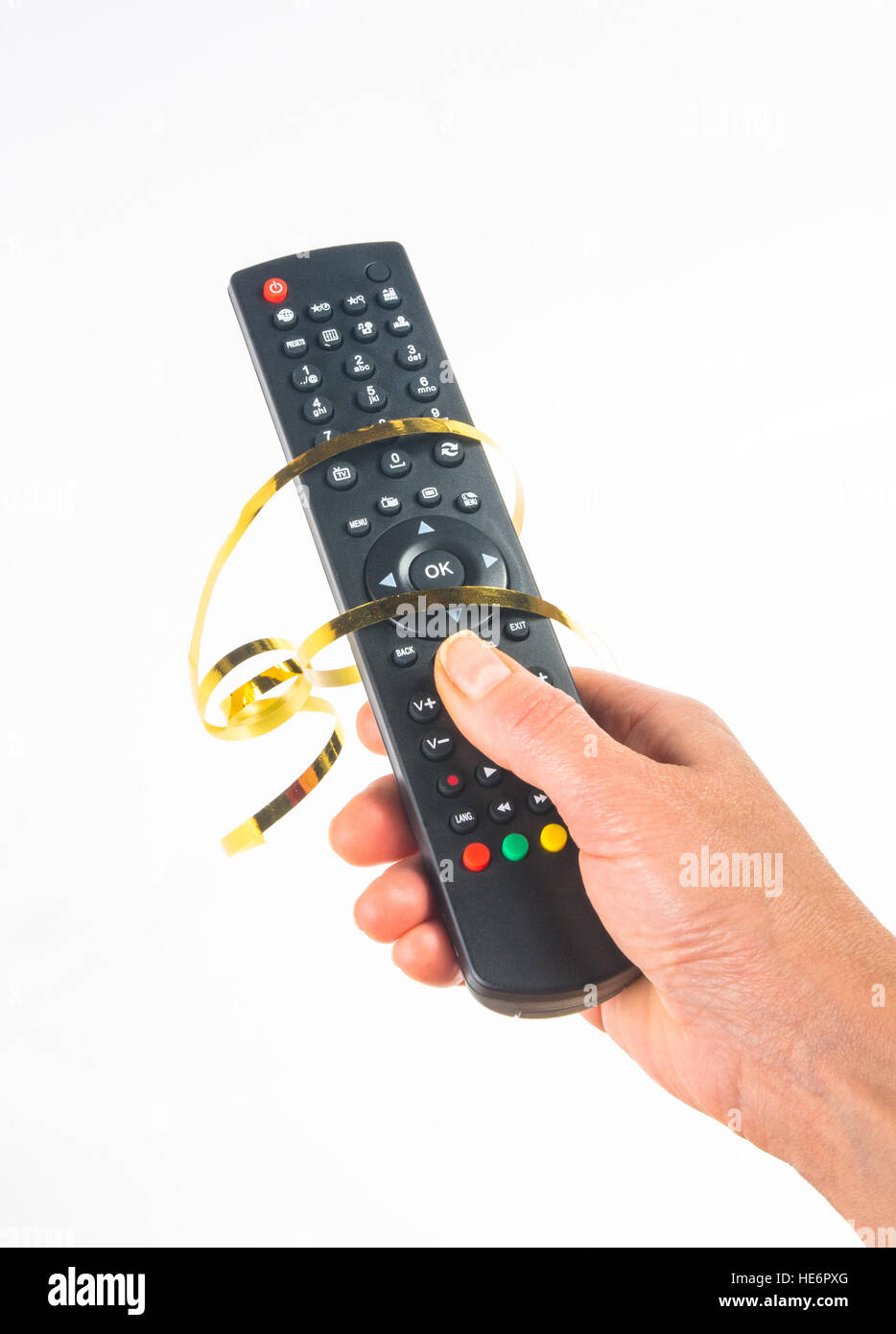 hand holding a remote control in a festive gold ribbon on white ...