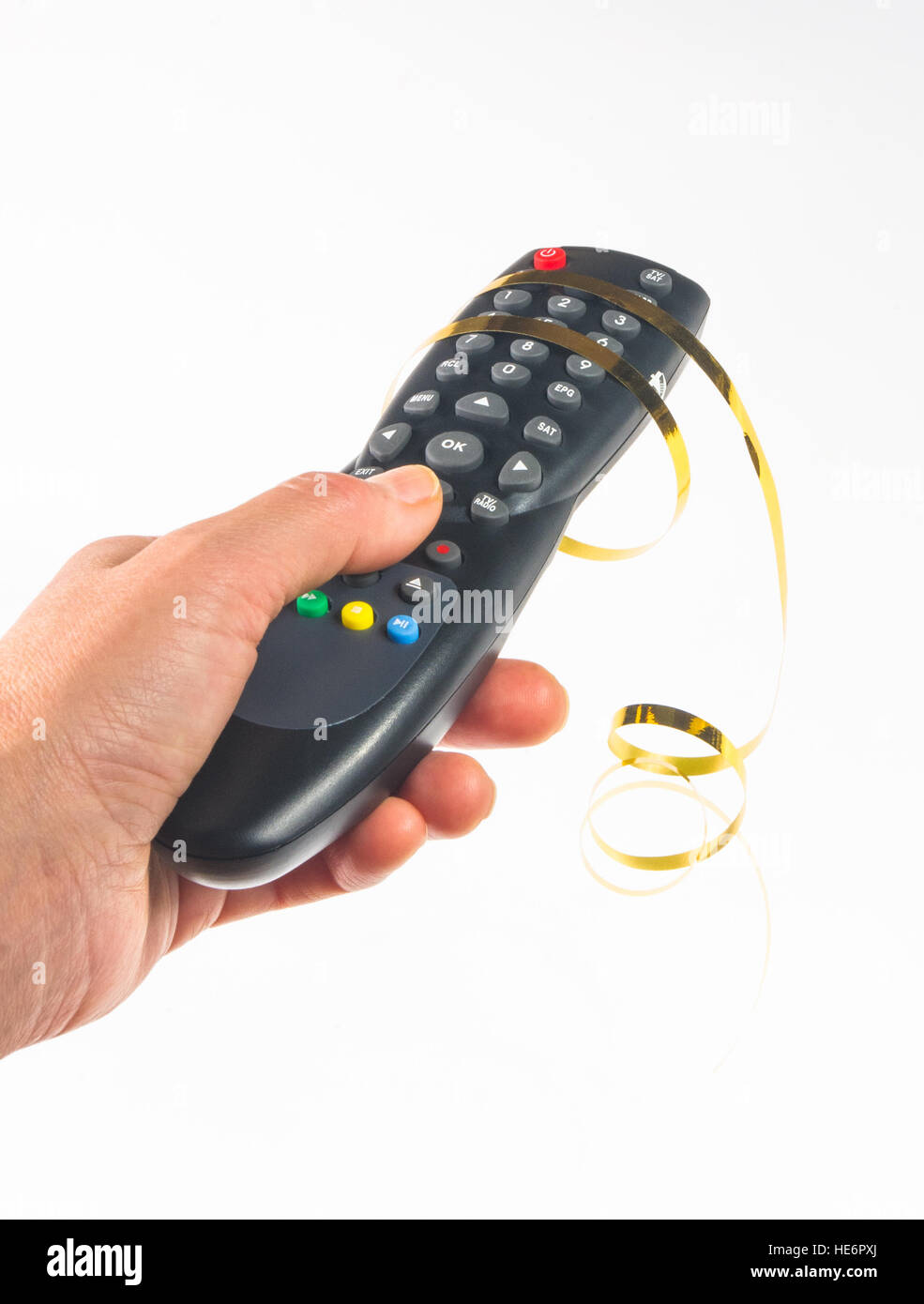 hand holding a remote control in a festive gold ribbon on white ...