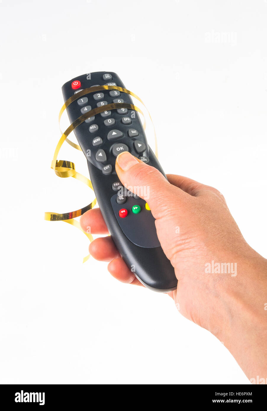 hand holding a remote control in a festive gold ribbon on white ...
