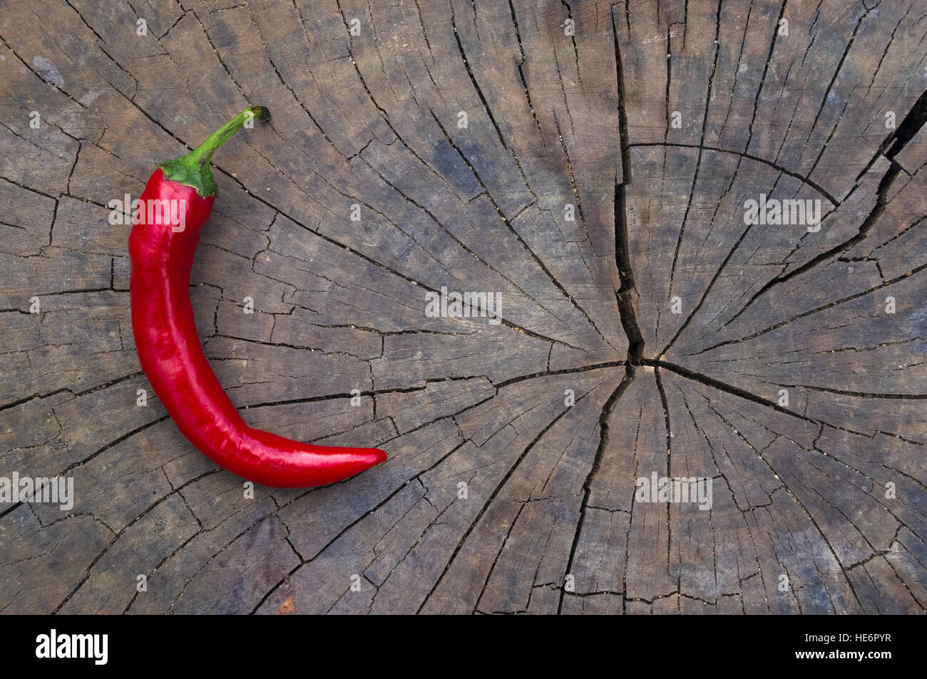 A pod of red hot chili peppers on the old worn wooden background Stock ...