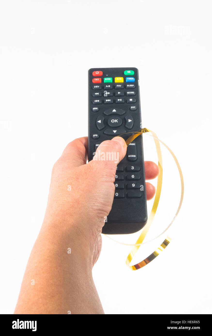 hand holding a remote control in a festive gold ribbon on white ...