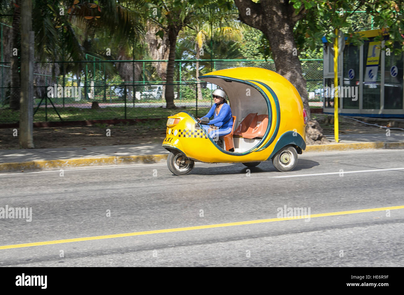 Woman driving a yellow coco taxi in Varadero, Cuba Stock Photo - Alamy