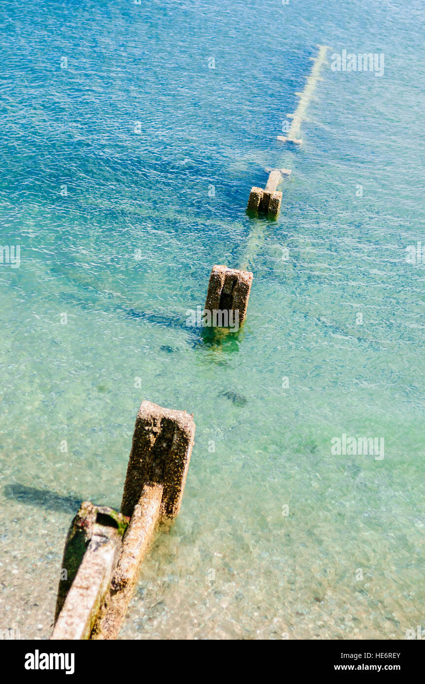 Broken, semi-sumberged tidal defences, built in the 1920s to prevent ...