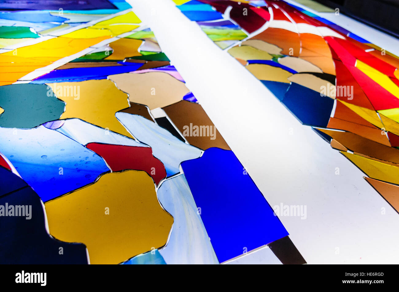 Glass is cut for a new window in a stained glass factory and repair ...