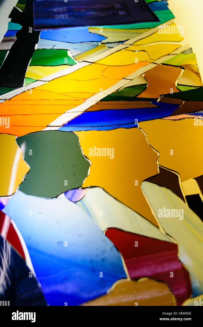 Glass is cut for a new window in a stained glass factory and repair ...