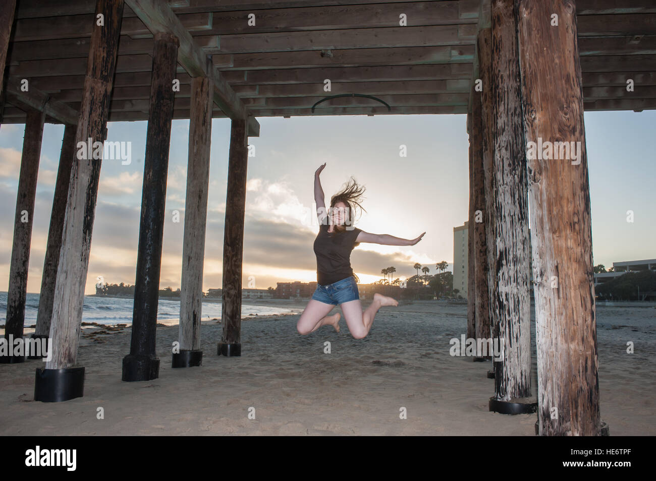 Young teen jumping for joy at Ventura Beach Stock Photo - Alamy