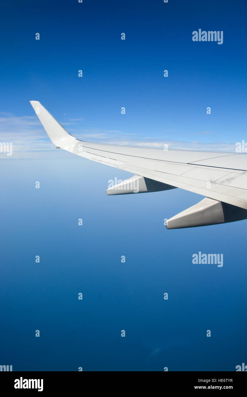 Airplane wing above the sky Stock Photo - Alamy