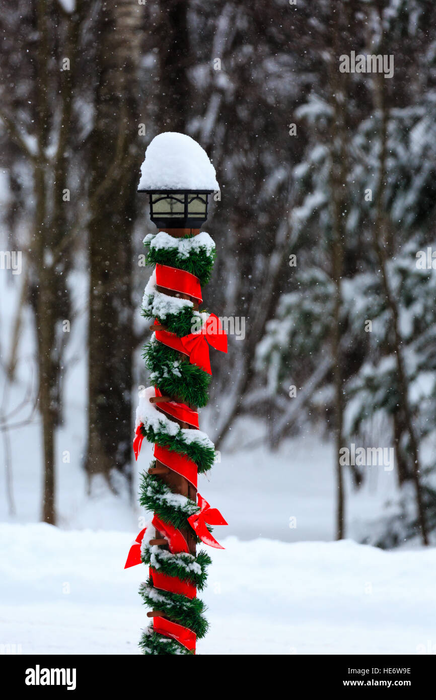 Outside light pole decorated for Christmas with red ribbon and green ...