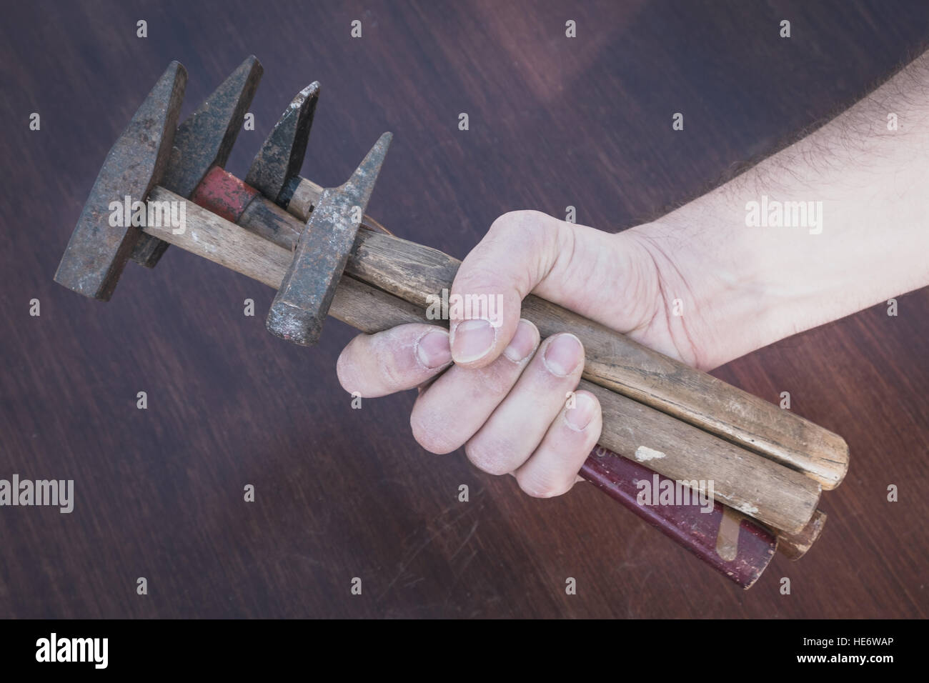 hand holding many hammers , retro filter Stock Photo - Alamy