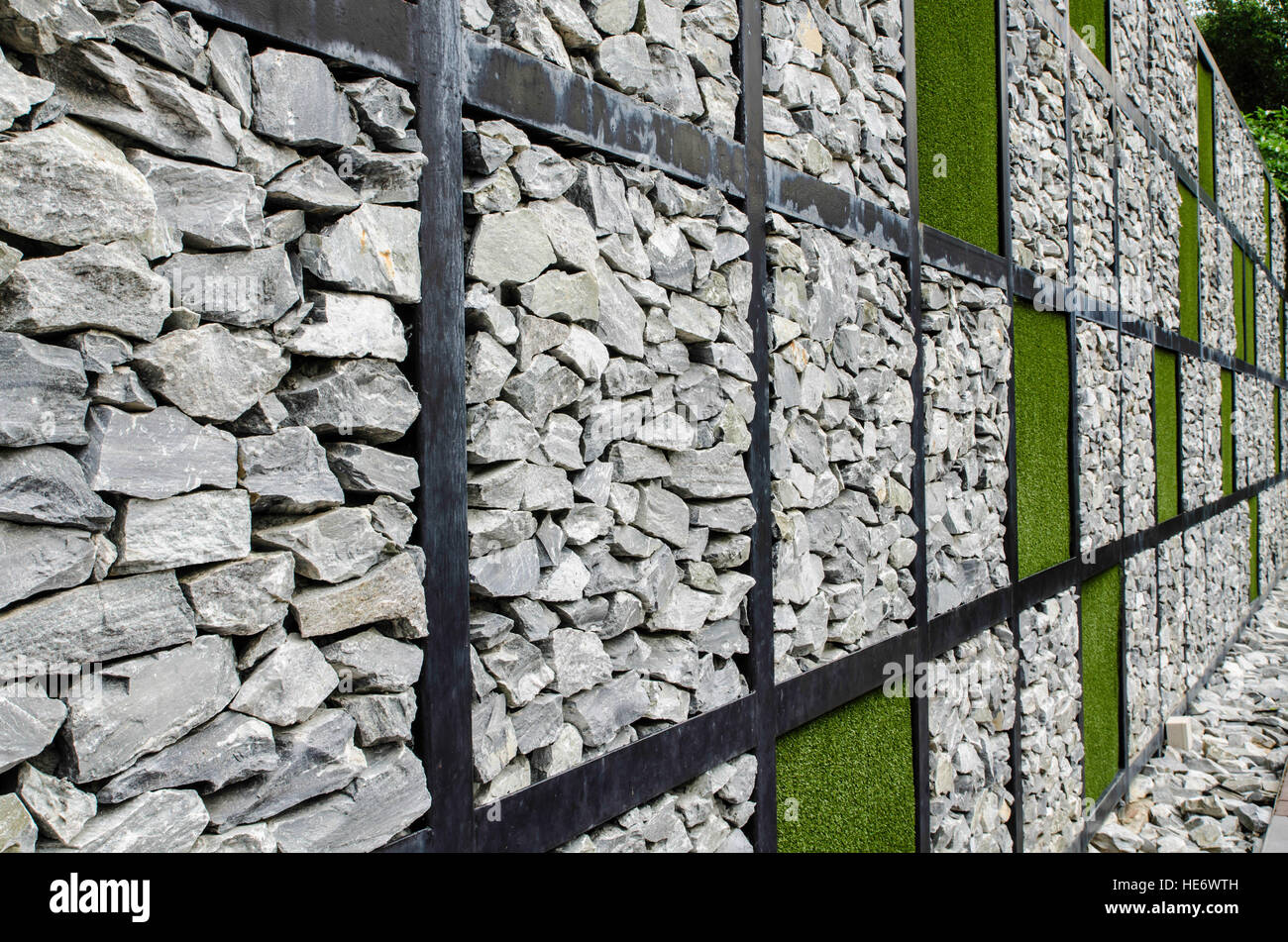Wall of stone and artificial grass background Stock Photo - Alamy