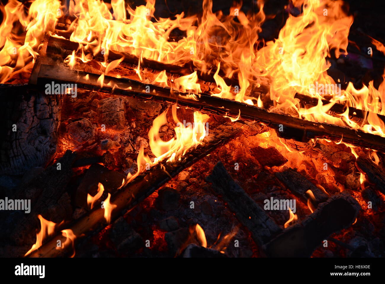 Burning wood at night Flame and fire sparks on dark abstract background ...