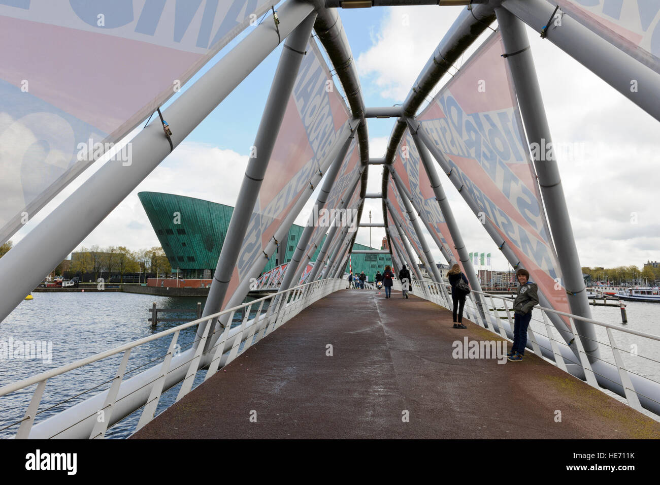 A modern bridge leading to the Nemo (Science) Museum, designed in the ...