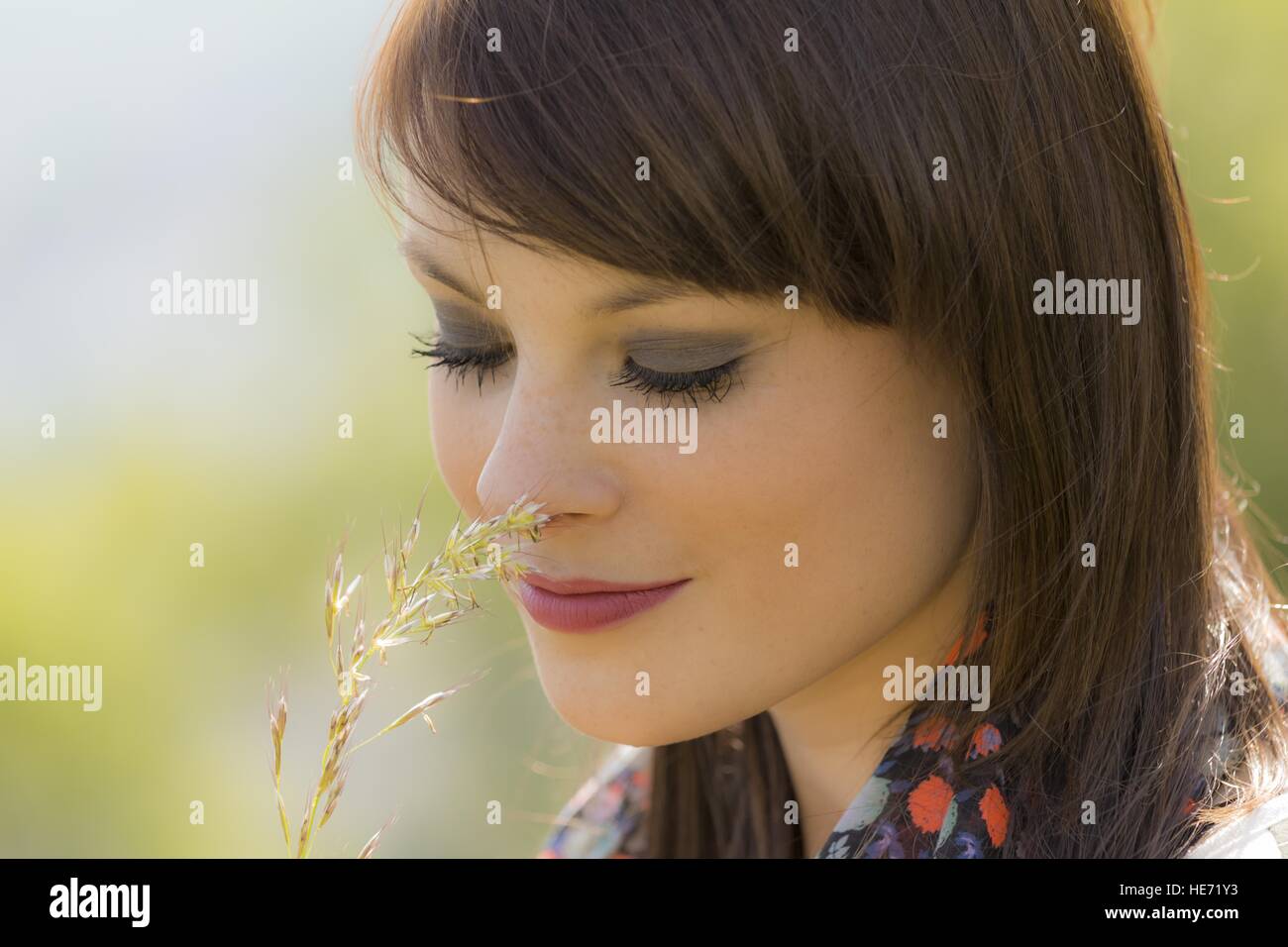 Beautiful happy girl is in love with nature. The young woman is ...