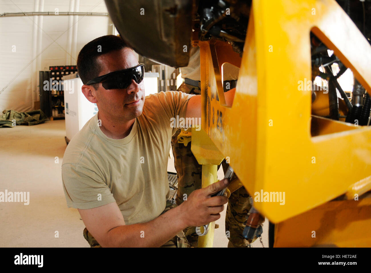 U.S. Army Sgt. Michael Johnson, an engine mechanic, works on the engine ...