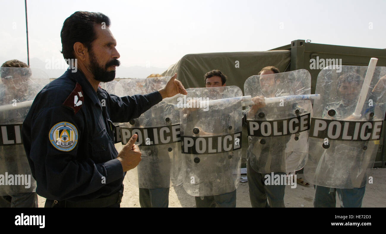 Afghan National Police (ANP) Maj. Muhammad Omar (left) explains riot ...