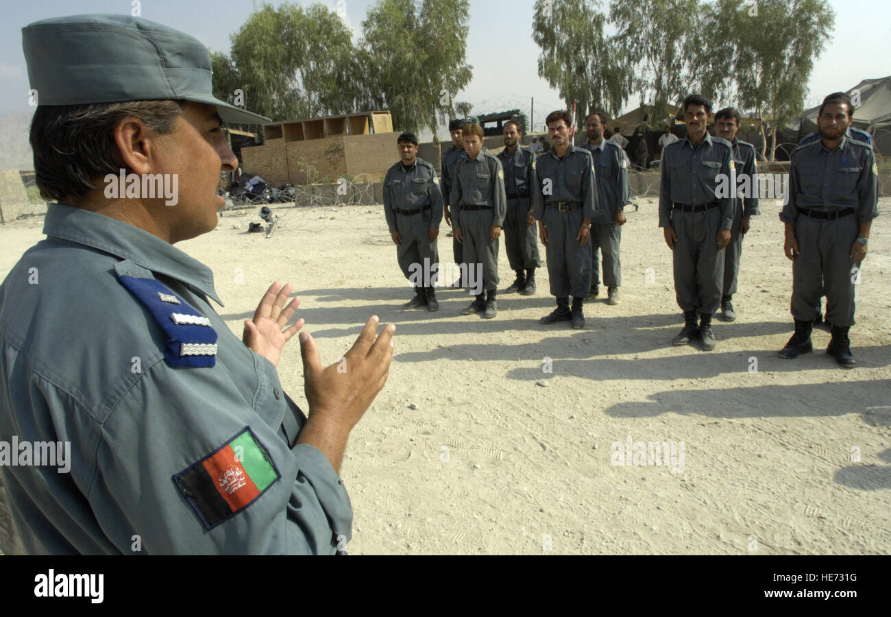 Afghan National Police (ANP) Capt. Muhammad Ajan (left) explains proper ...