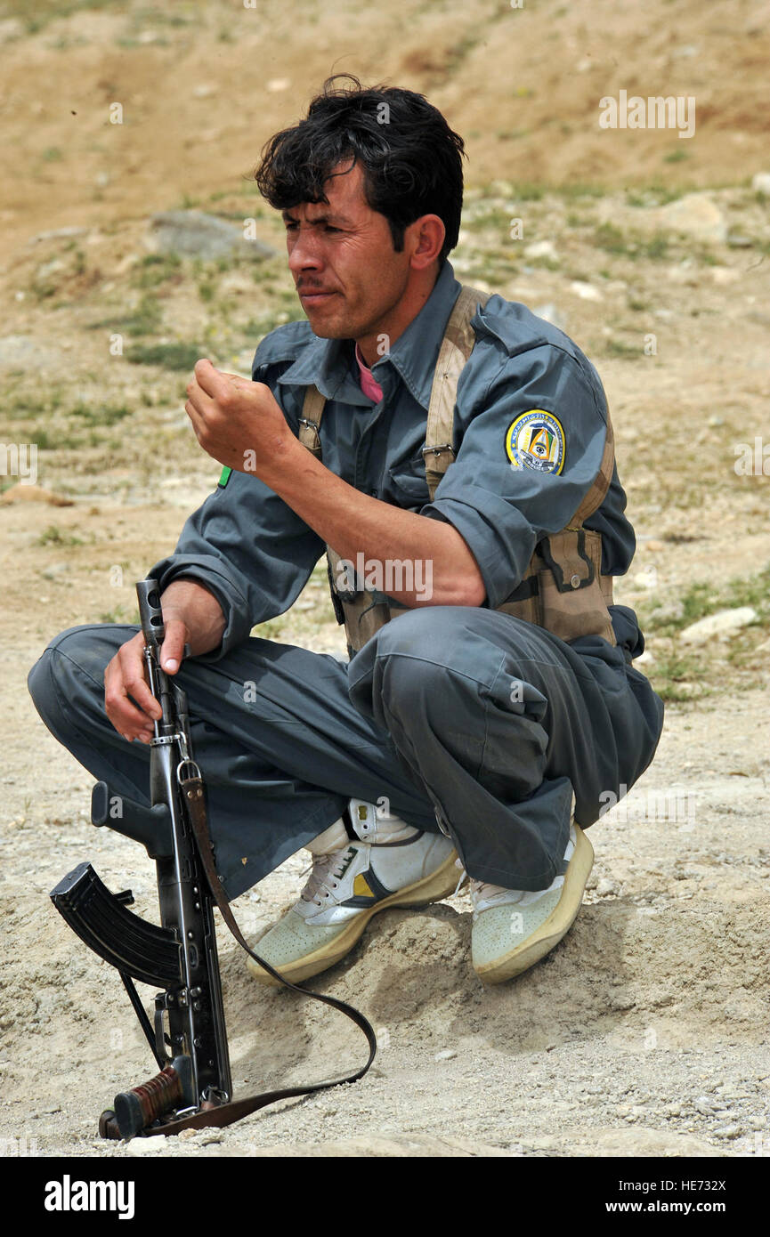 An Afghan National Police officer participates in a shura in Jaghatu ...