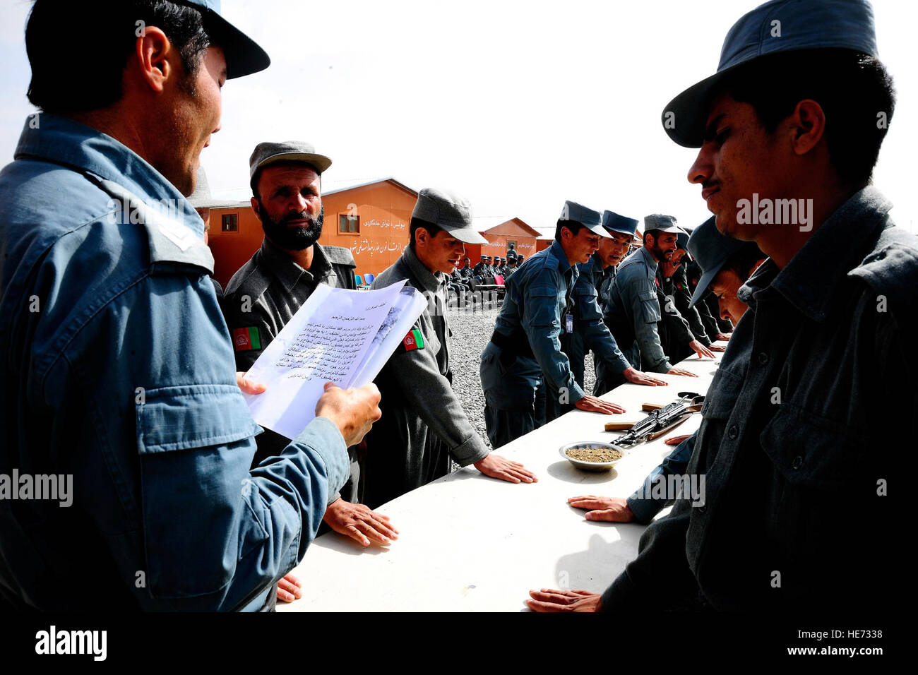 An Afghan National Police instructor administers the Afghan police oath ...