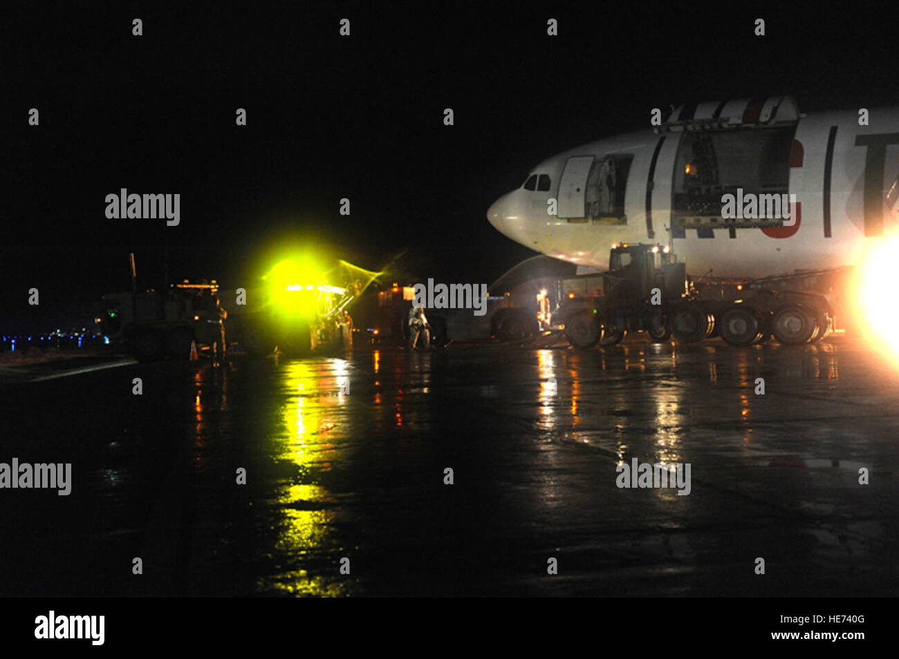 U.S. Air Force Airmen, Army Soldiers, and contractors move an Airbus ...