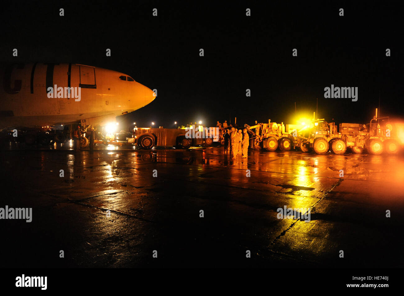 U.S. Air Force Airmen, Army Soldiers, and contractors move an Airbus ...