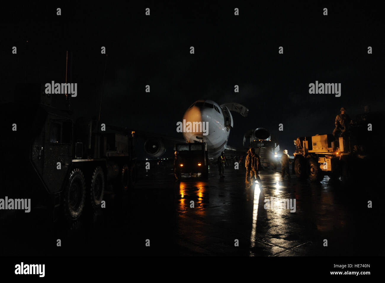 U.S. Air Force Airmen, Army Soldiers, and contractors move an Airbus ...