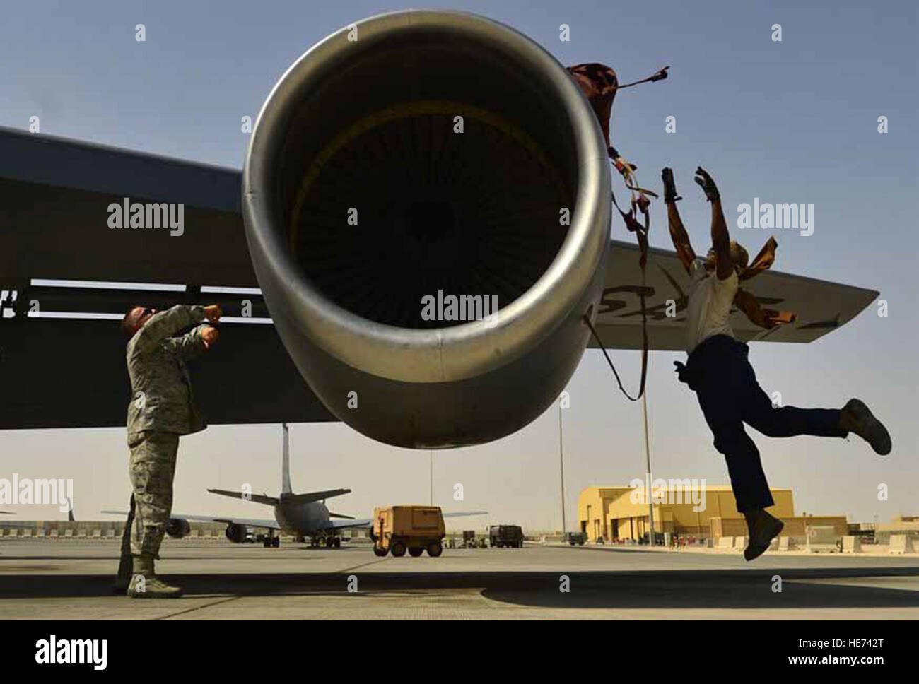 Senior Master Sgt. Ernie Goethe assists Senior Airman Darius Gamble to ...