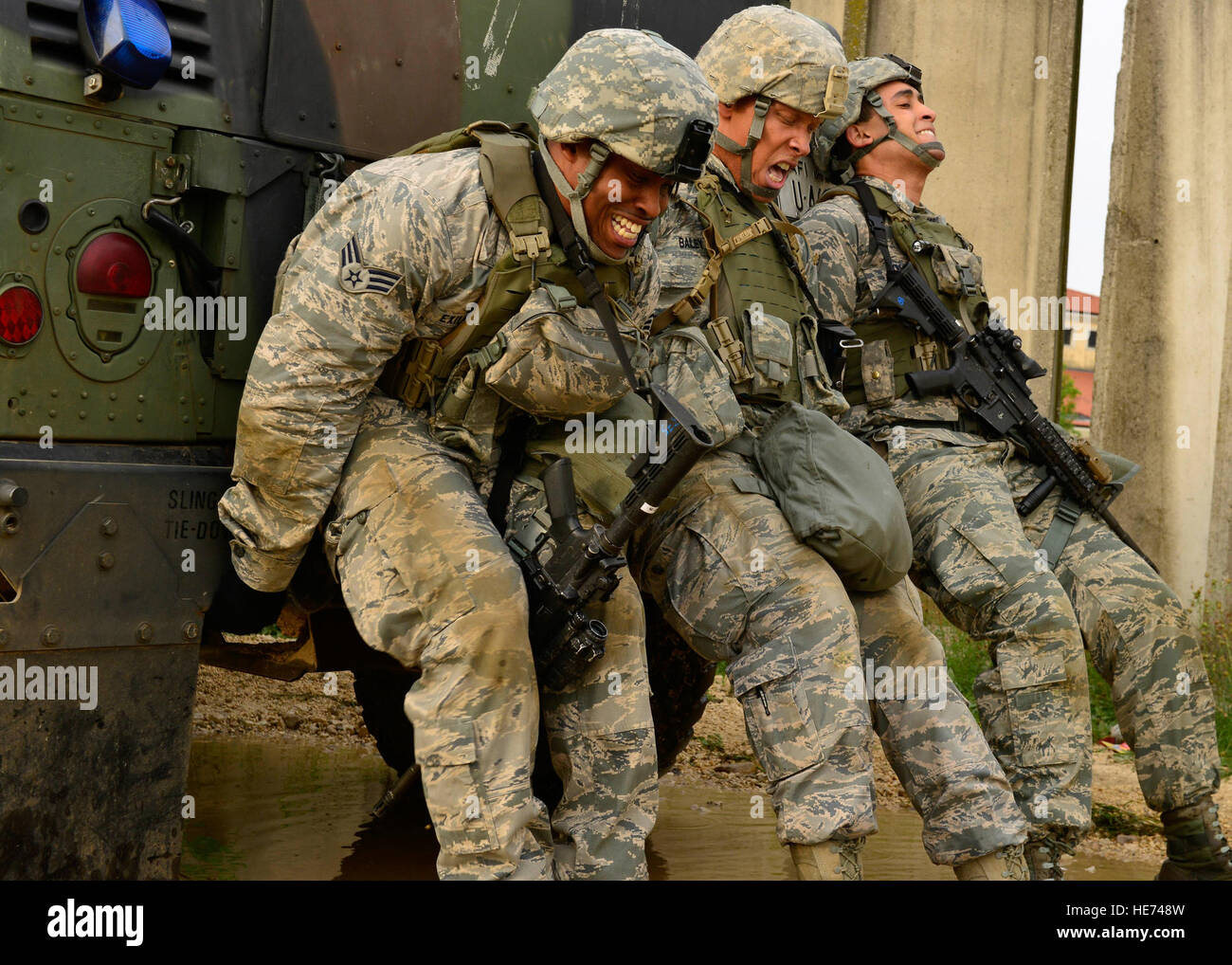 U.S. Air Force defenders push a Humvee out during the Security Forces ...