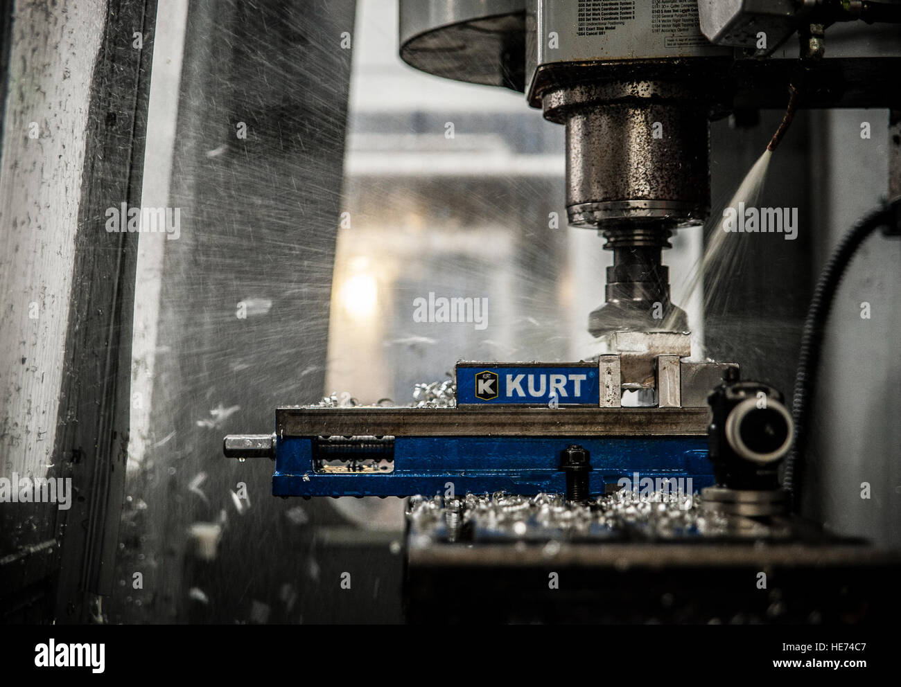A computer operated mill shaves a thin layer of aluminum off a block of ...