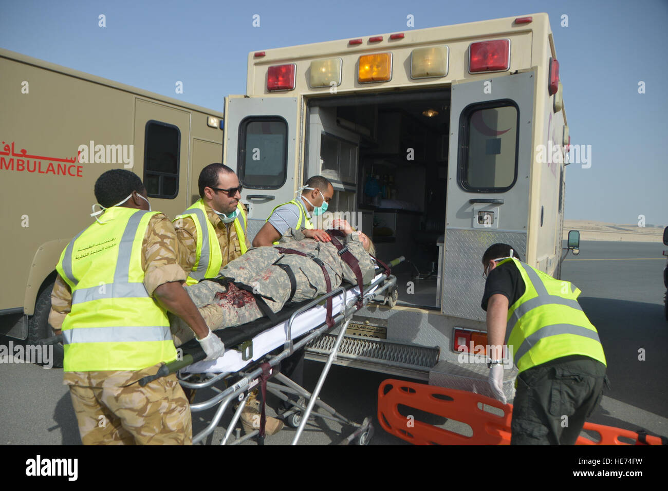 Qatar Emiri Air Force first responders prepare to transport a simulated ...
