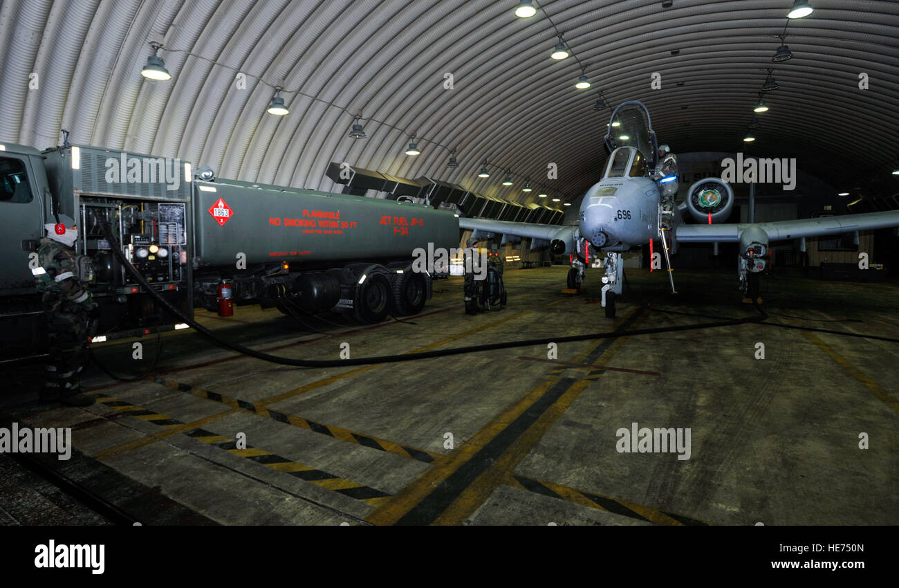 Airmen load fuel into an A10 Thunderbolt II prior to being prepped for ...