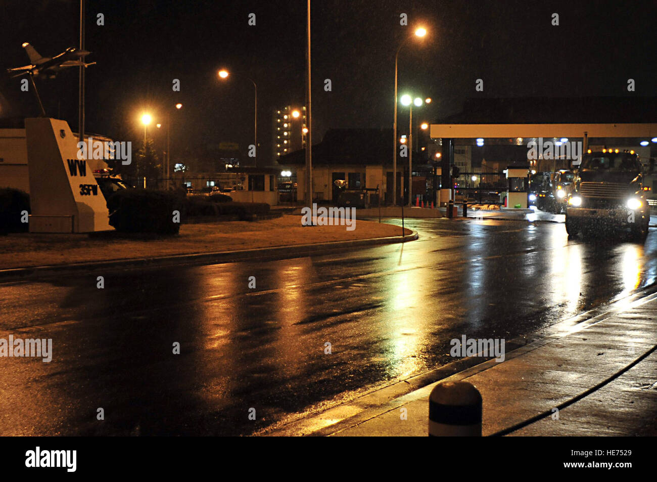 A convoy of trucks and buses enters through the base's main gate Mar ...