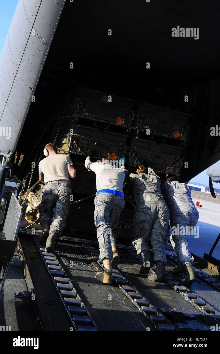 U.S. Air Force airmen from the 721st Aerial Port Squadron load cargo ...