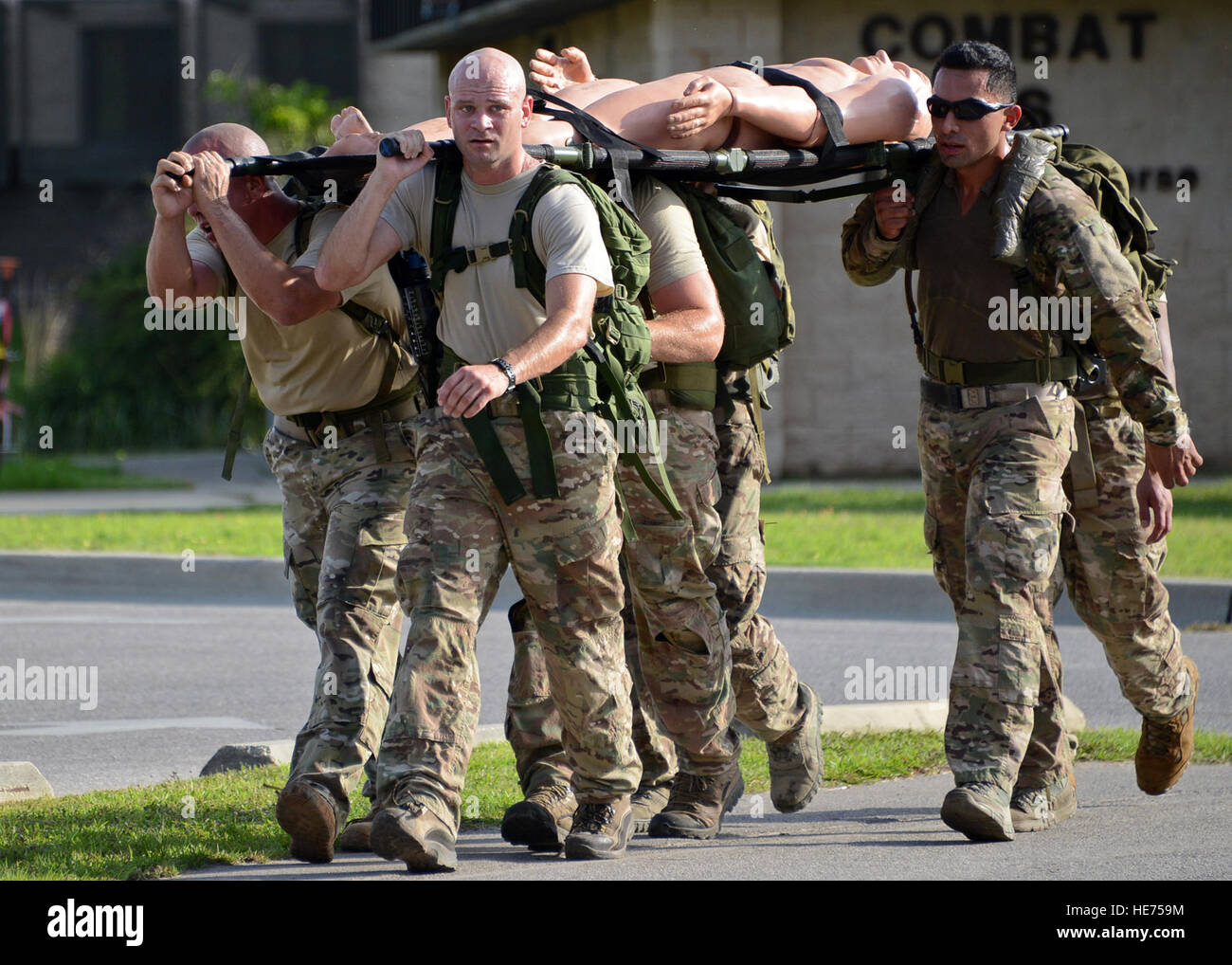 Members of the 23rd Special Tactics Squadron litter-carry a medical ...