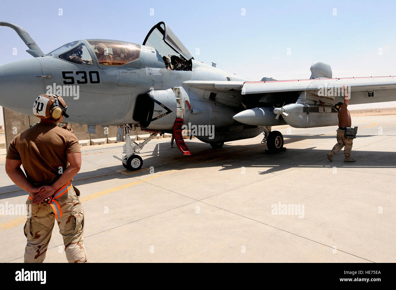Navy maintenance personnel conduct final pre-flight checks as an A6B ...