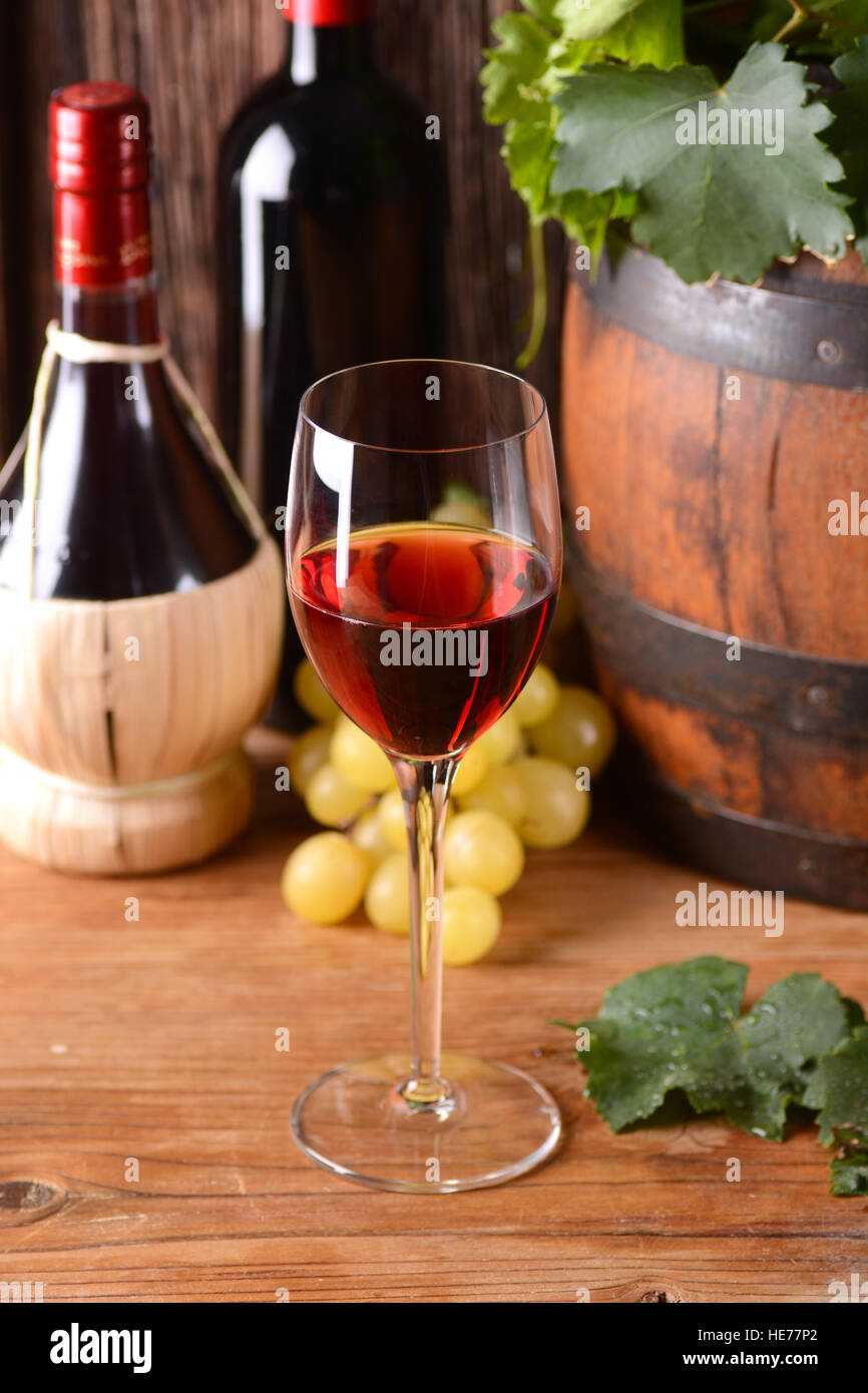 Italian red wine with cask on wood table Stock Photo - Alamy
